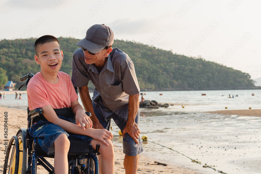Asian special child and Father in wheelchair on the beach with ...