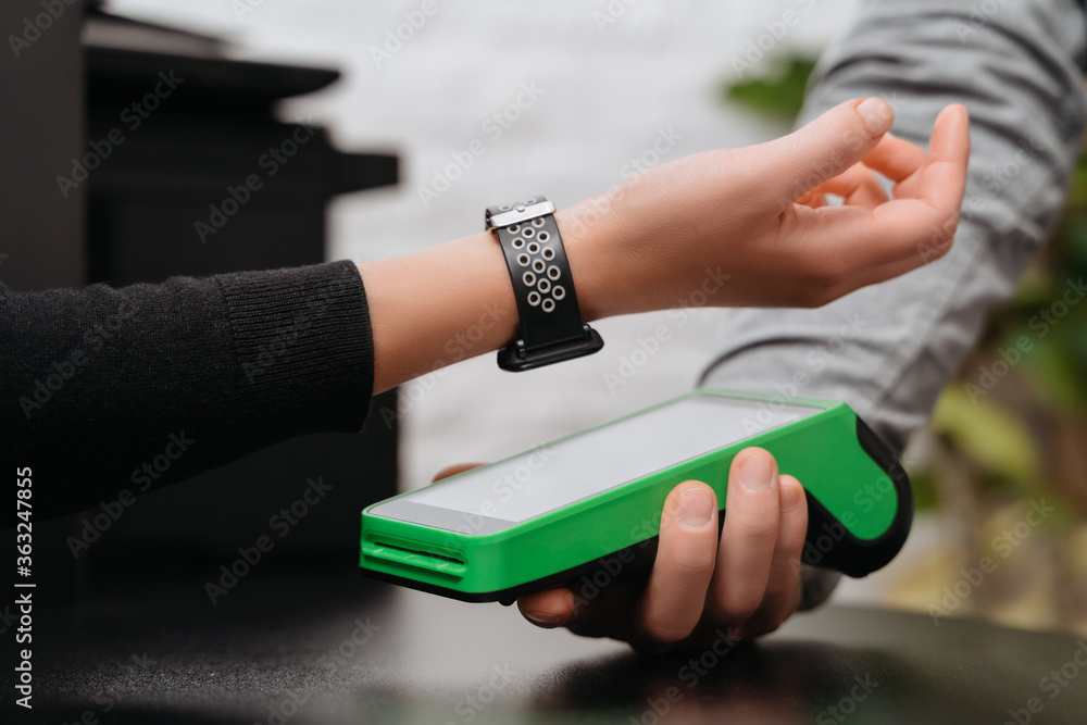 Client making contactless payment by smart watch with NFC technology ...
