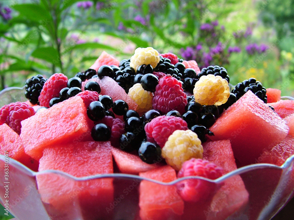 Colorful fruit salad made from garden-grown fruits: watermelon, red and ...