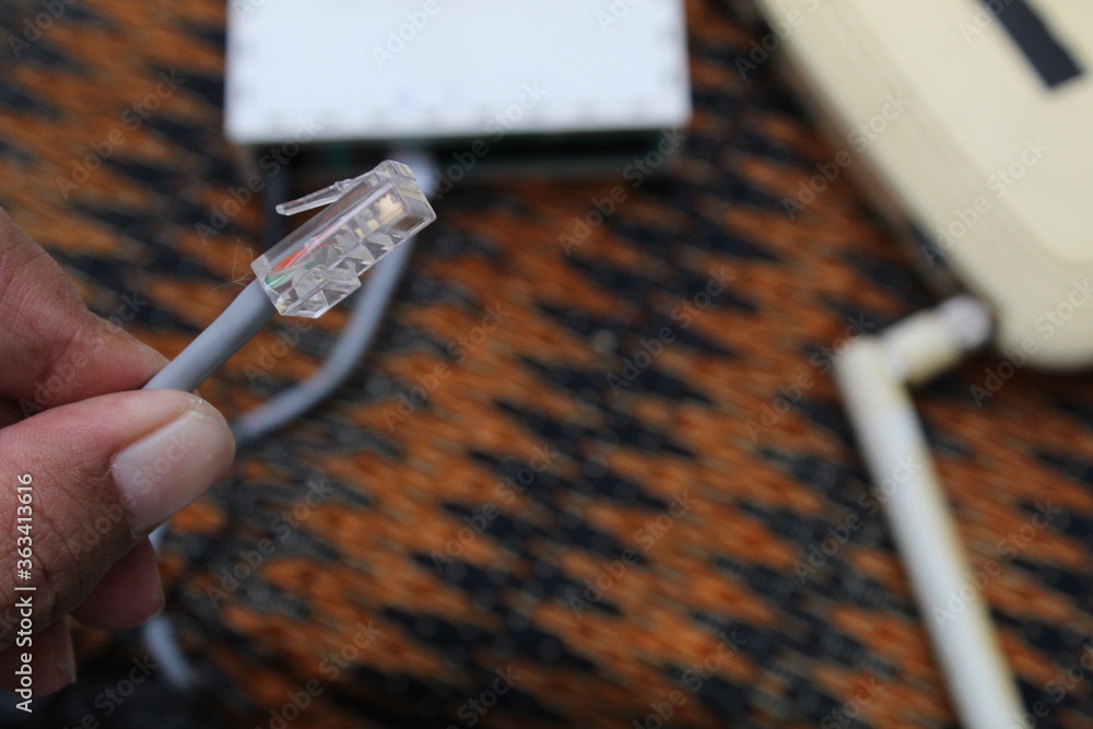 Selective focus to RJ45 Connector with crimping RJ45 tool on blurry ...