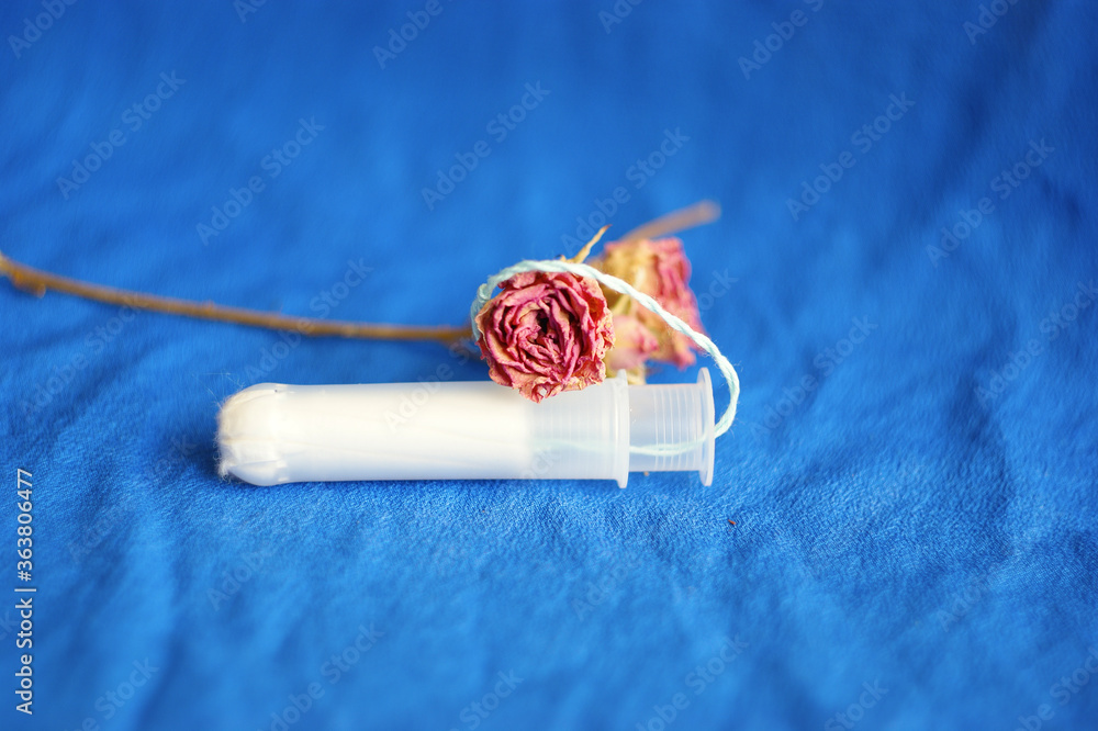 menopause concept. dried red rose lies on a woman tampon. dried rose ...
