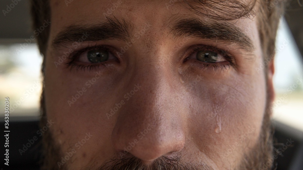 Stock-Foto „Handsome young man crying looking at camera. Tears run down ...