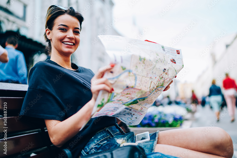 Half length portrait of successful tourist resting on bench during ...