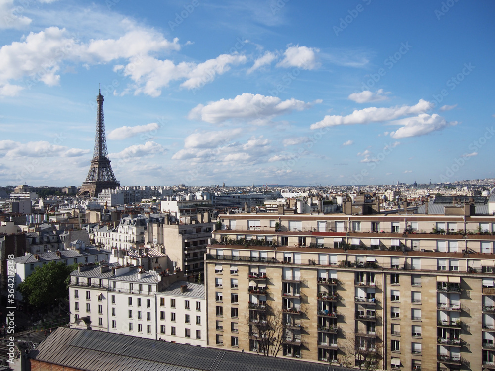 Paris skyline with the Eiffel Tower shining during the day when clouds ...