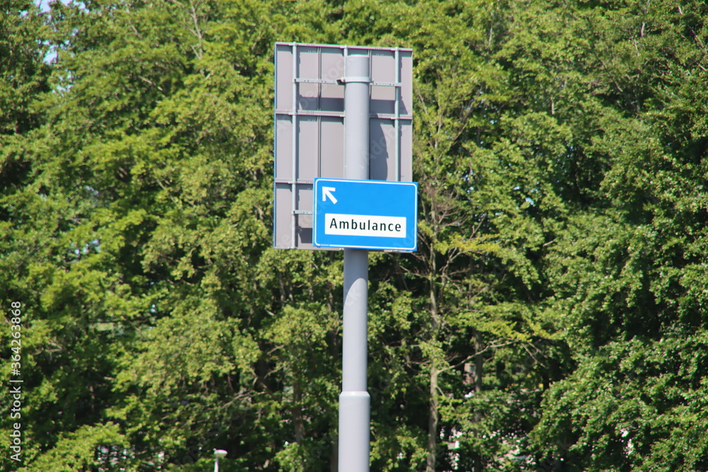 Direction sign in Blue and white heading the Emergency route for ...
