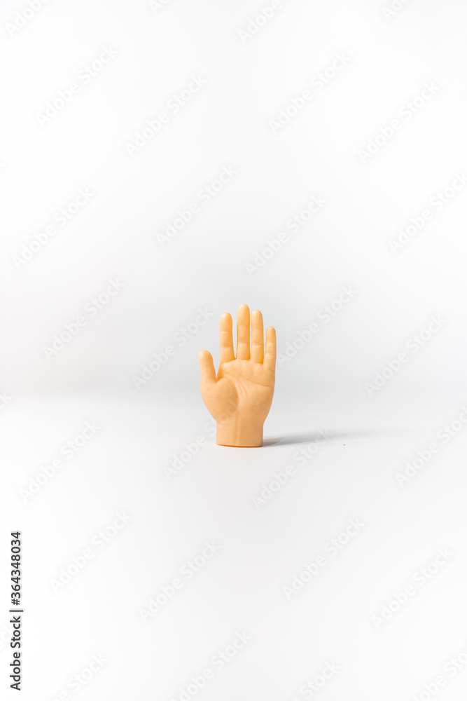 fake Hand raised against white background Stock Photo | Adobe Stock