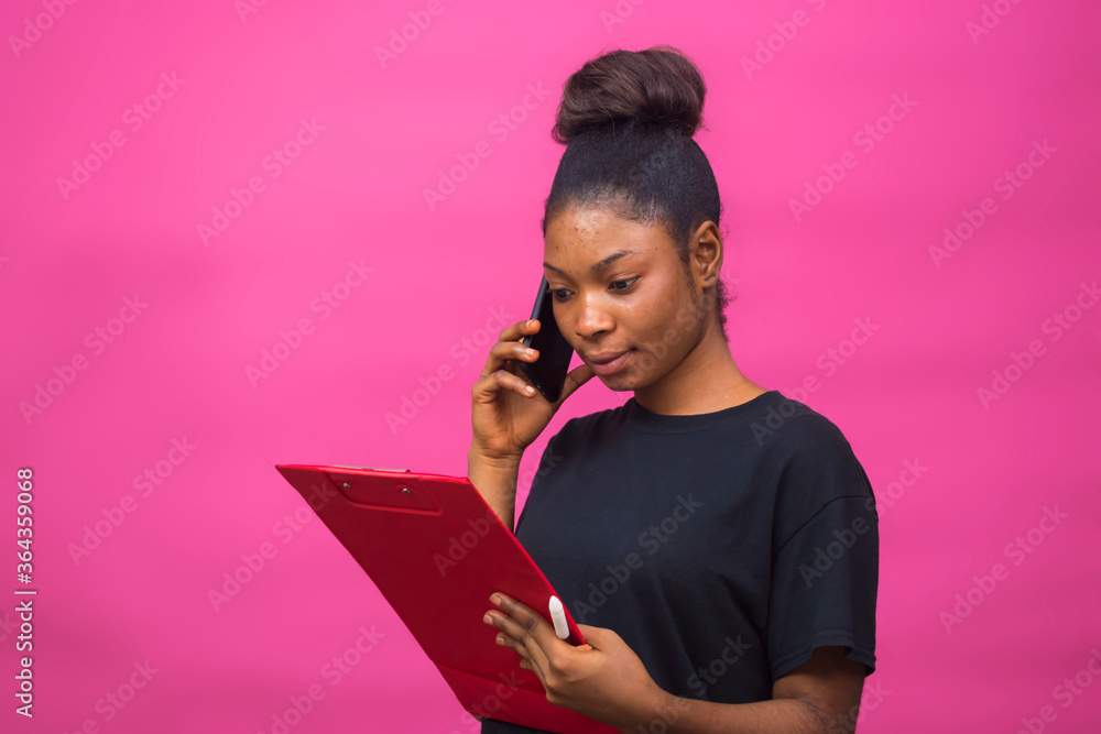 Stock-Foto „young beautiful black lady holding her notepad and using ...