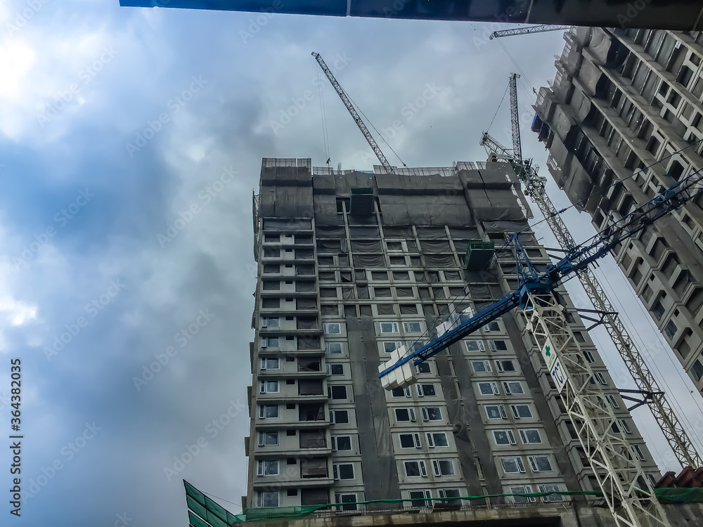 Luffing jib tower crane at high rise building construction site project ...