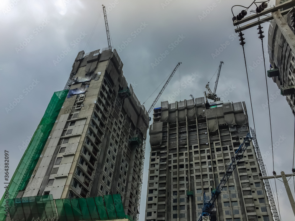 Luffing jib tower crane at high rise building construction site project ...