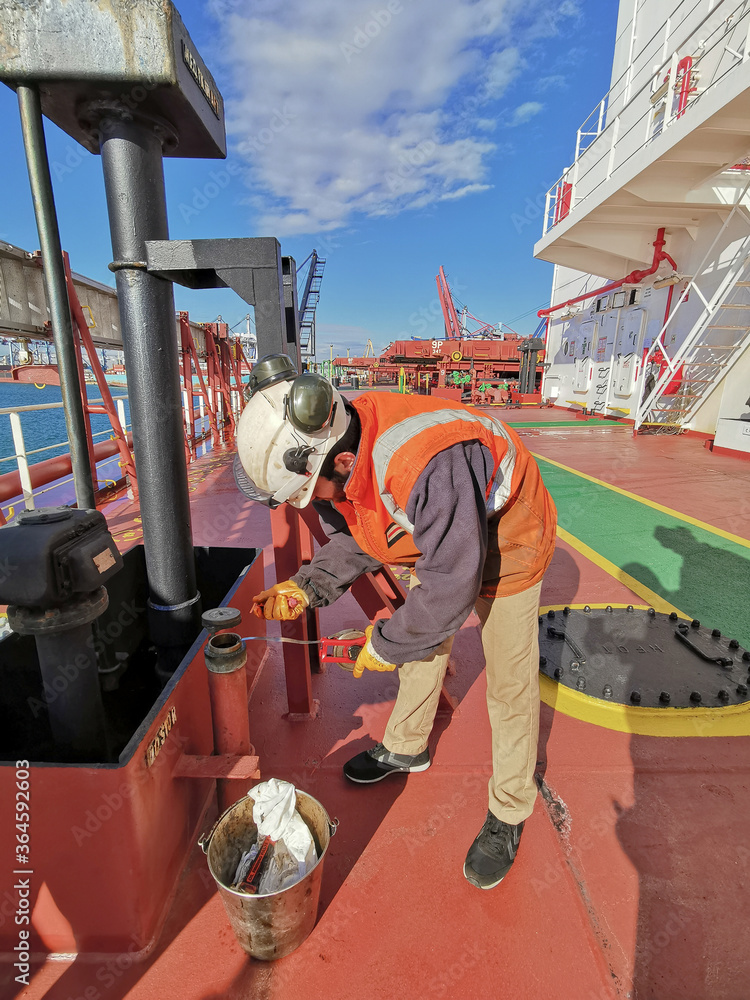 Sounding of bunker tanks during bunker survey on board of bulk carrier ...