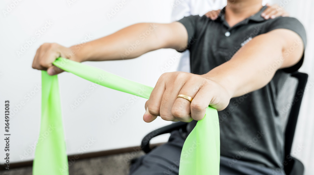 Female physiotherapists are helping male patients with arm injuries ...