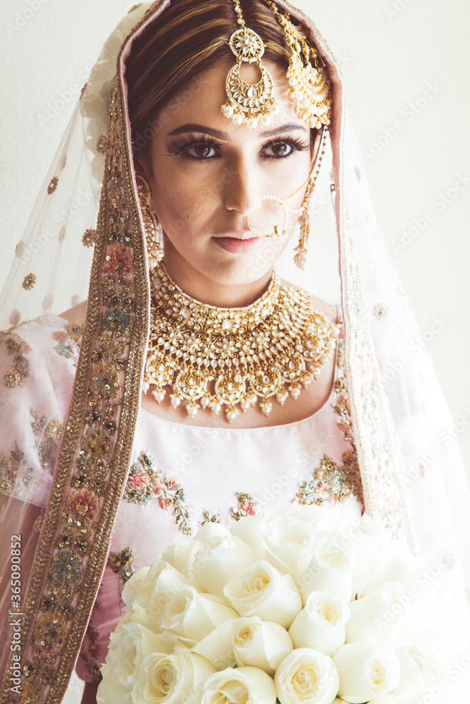 Beautiful female model wearing traditional Sikh wedding attire as she ...