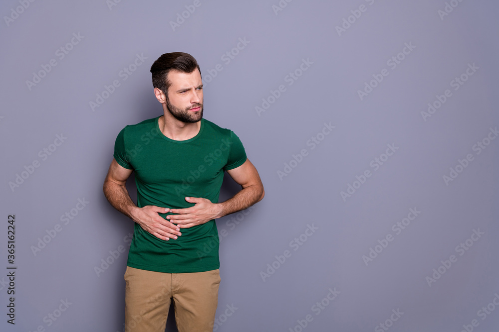 Portrait of frustrated man eat something wrong suffer stomach ache ...