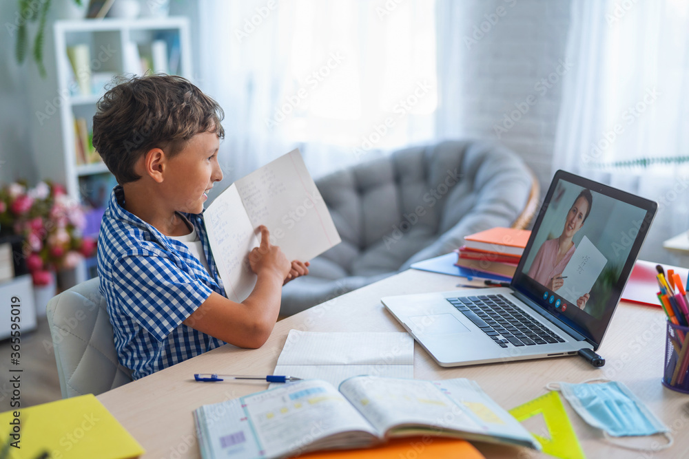 School child shows homework through having video conference chat with ...