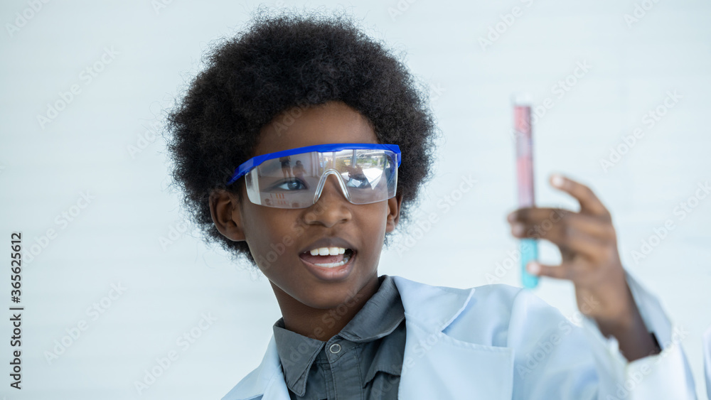 Kid in lab coat learning chemistry in school laboratory, Kid scientist ...