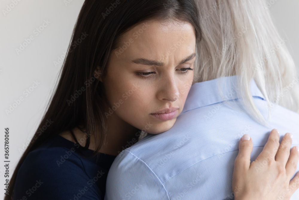 Grown up sad millennial loving daughter embraces elderly mother, rear ...
