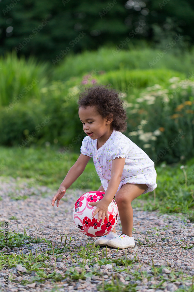 Full length vertical portrait of pretty mixed-raced toddler girl ...