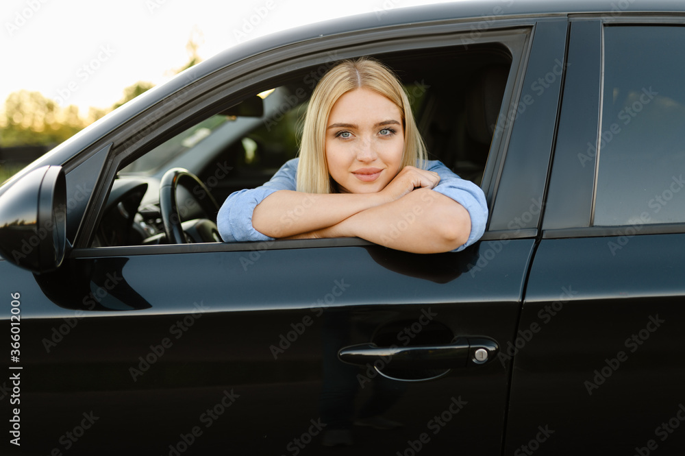 Female student poses in car, driving school Stock Photo | Adobe Stock