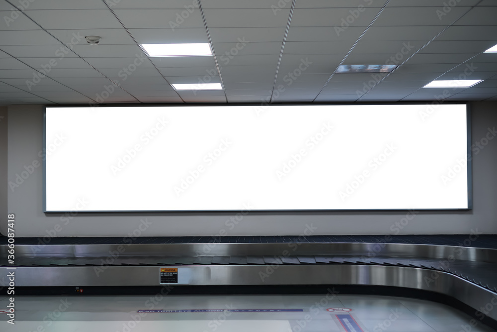 LCD Blank billboard at conveyor belt luggage in airport. Wide screen ...