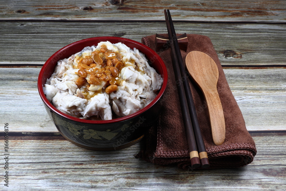 Traditional boiled or steamed fist meat topping on cooked rice in the ...