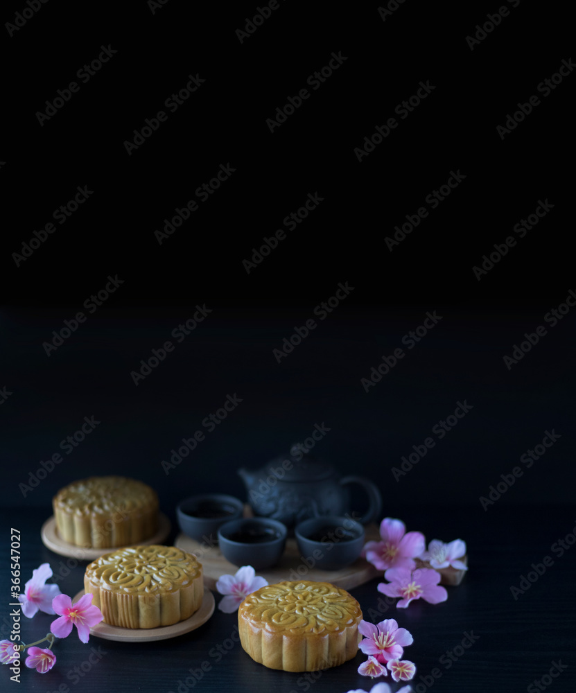 Traditional Baked Mooncake on Dark Background. Mooncakes with Sakura ...