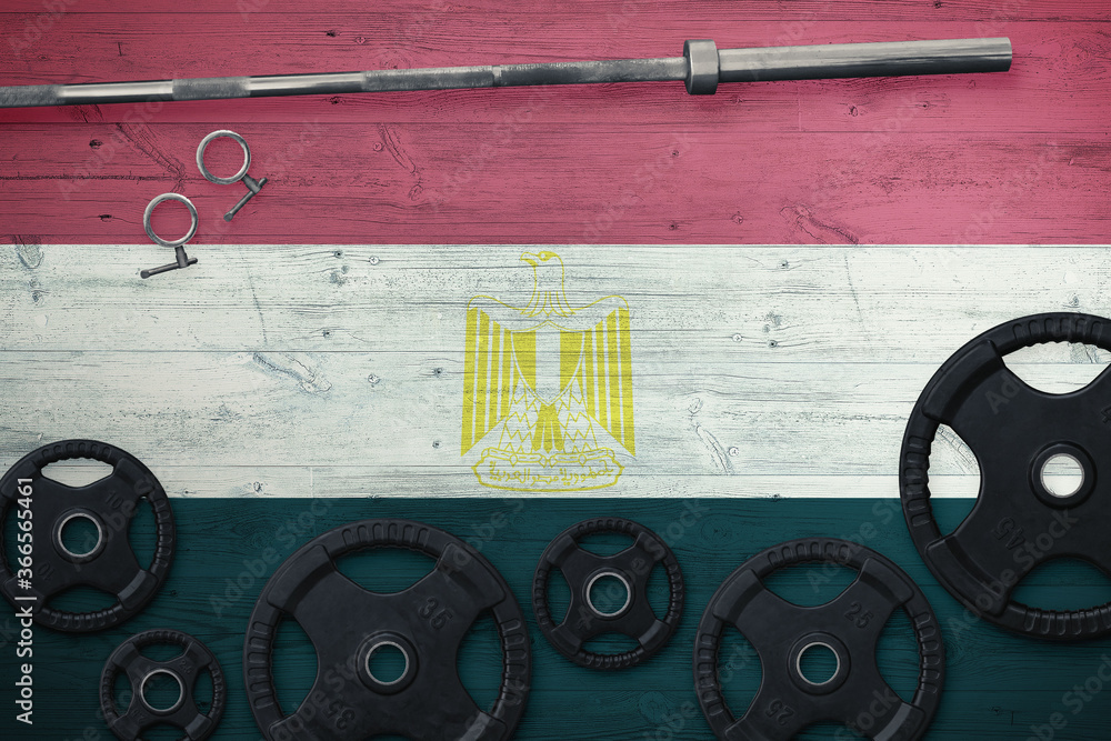 Egypt gym concept. Top view of heavy weight plates with iron bar on ...
