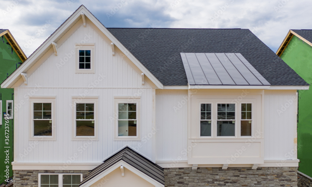 Stylish, modern American house facade with white vertical siding ...