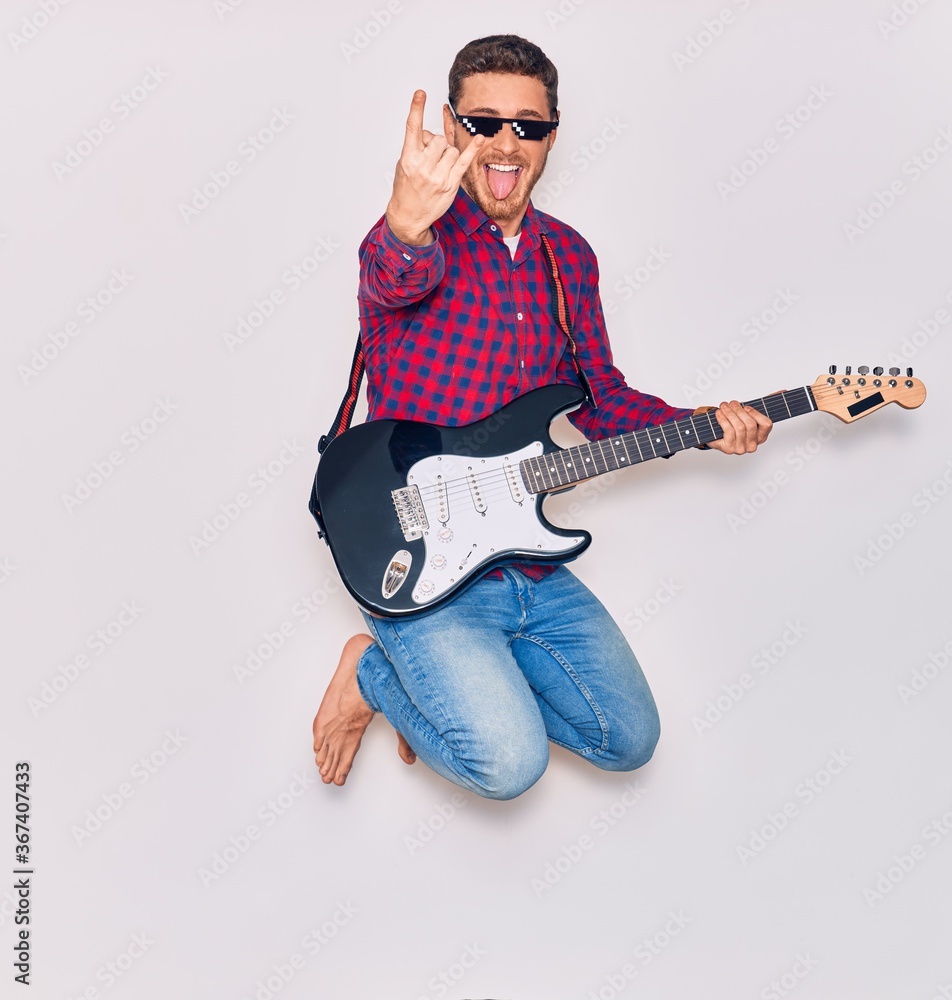 Young hispanic artist man wearing thug life sunglasses with open mouth ...