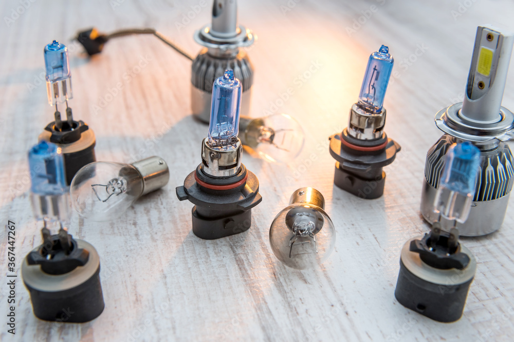 Set of different auto lamp for repair headlight on white wooden ...