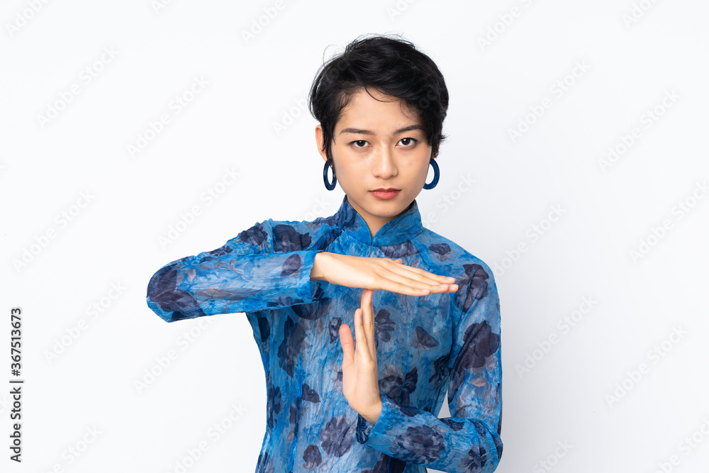 Young Vietnamese woman with short hair wearing a traditional dress over ...