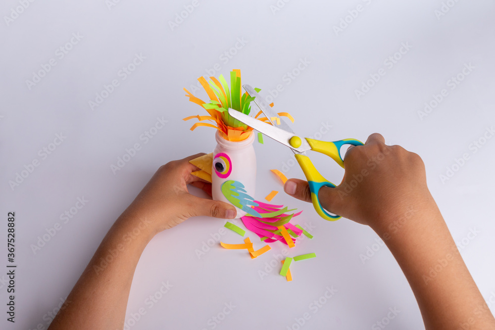 child makes a parrot craft from recycled yogurt bottle, DIY ...