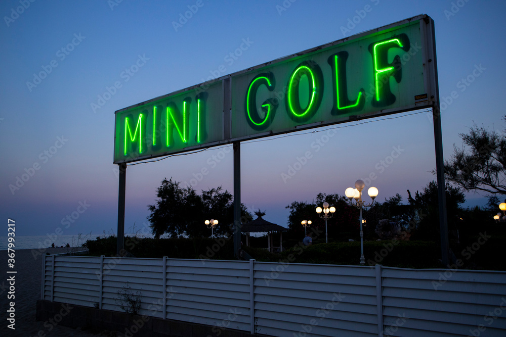 Mini Golf sign with neon letters at dusk Stock Photo | Adobe Stock
