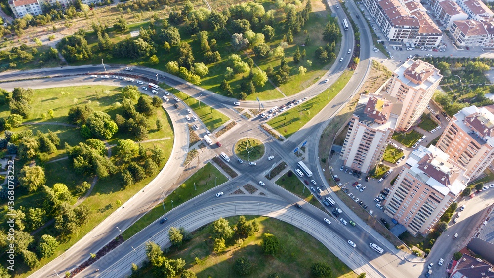 Aerial view of the junction road. There is a roundabout in the middle ...