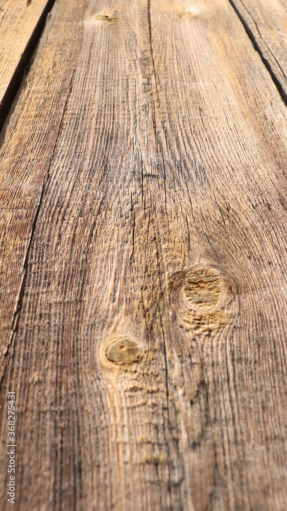 raised surface of dry brown wood with lines and cracks in the structure ...