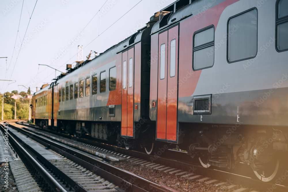 Passenger electric train moving on the railway. Stock Photo | Adobe Stock