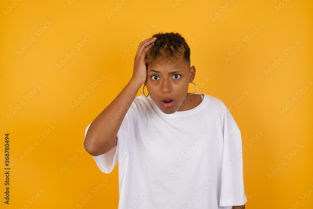 Embarrassed Young African American girl with afro short hair wearing ...