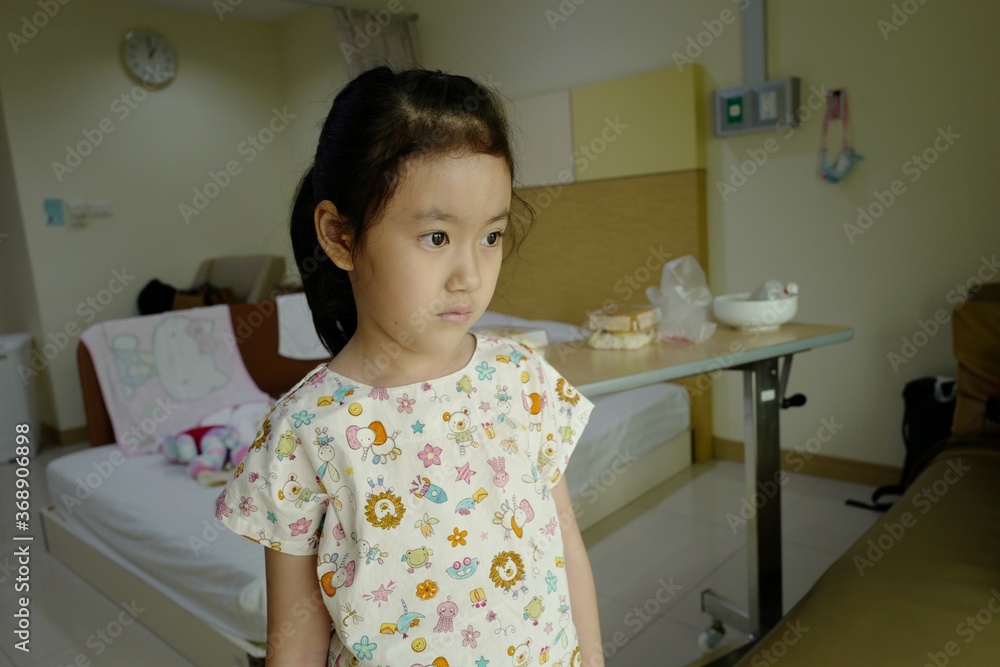 Illness asian child admitted in hospital while saline intravenous (IV ...