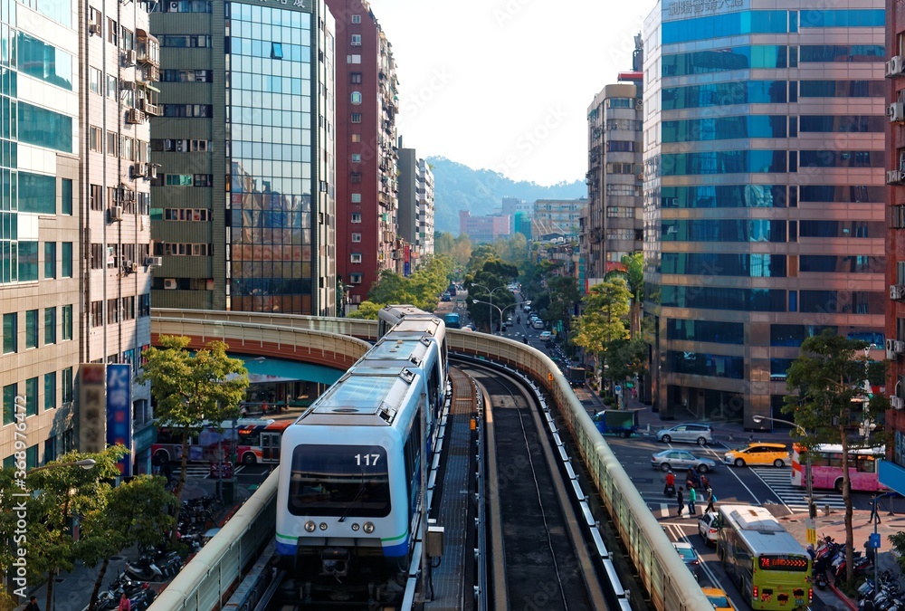 View of a train traveling on elevated rails of Taipei Metro System and ...