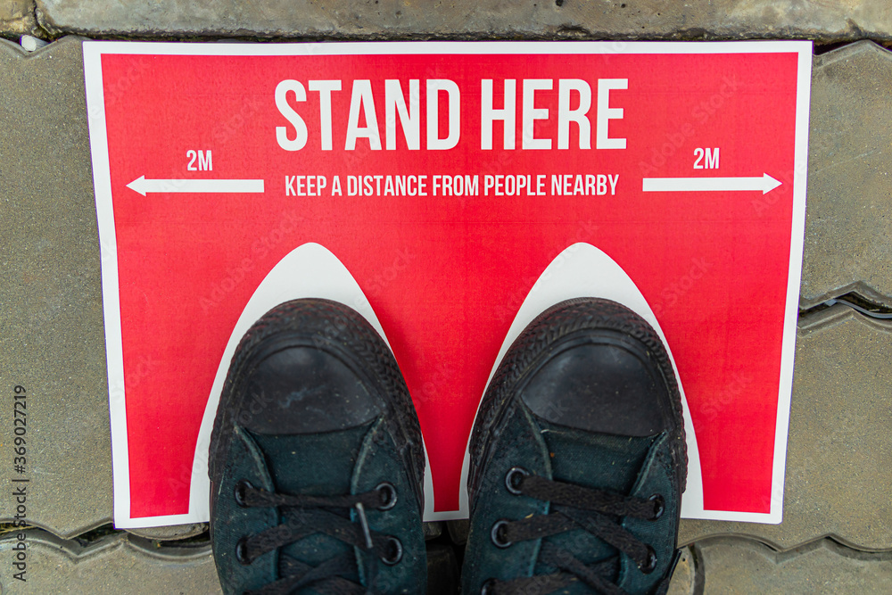 Social distancing sign for people line up in front of grocery store to ...