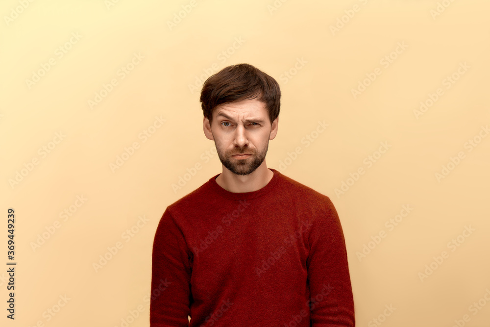 Bad connection. Photo of young man with beard wearing sweater, frowns ...