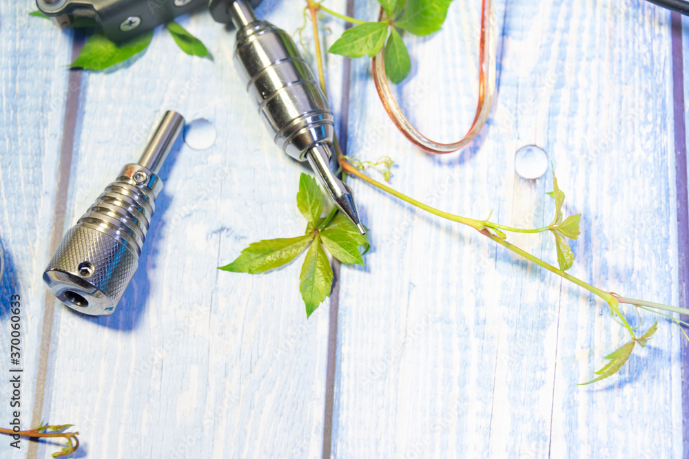 complete equipment of tattooing machines. blue wood and brick ...