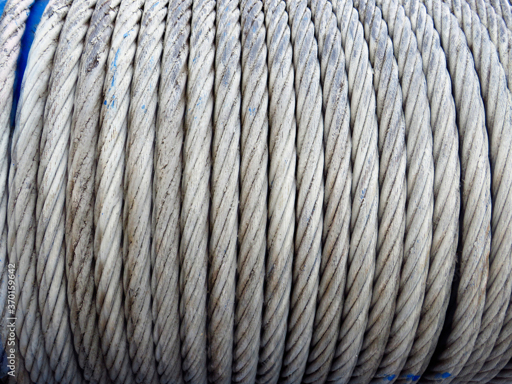Thick nautical rope bottom wrapped around to be caught. Full frame with ...