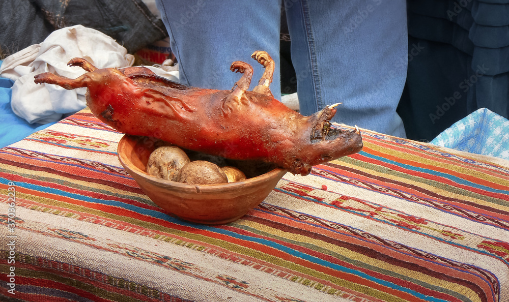 Roasted cuy (guinea pig) with cooked potatoes, a traditional peruvian ...