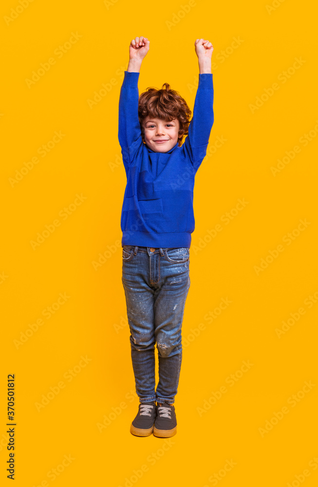 Happy boy with arms raised Stock Photo | Adobe Stock