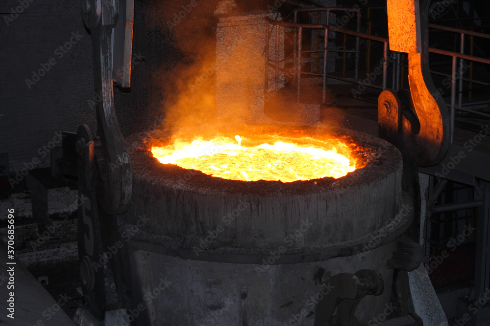 Steel production in electric furnaces. Sparks of molten steel. Electric ...