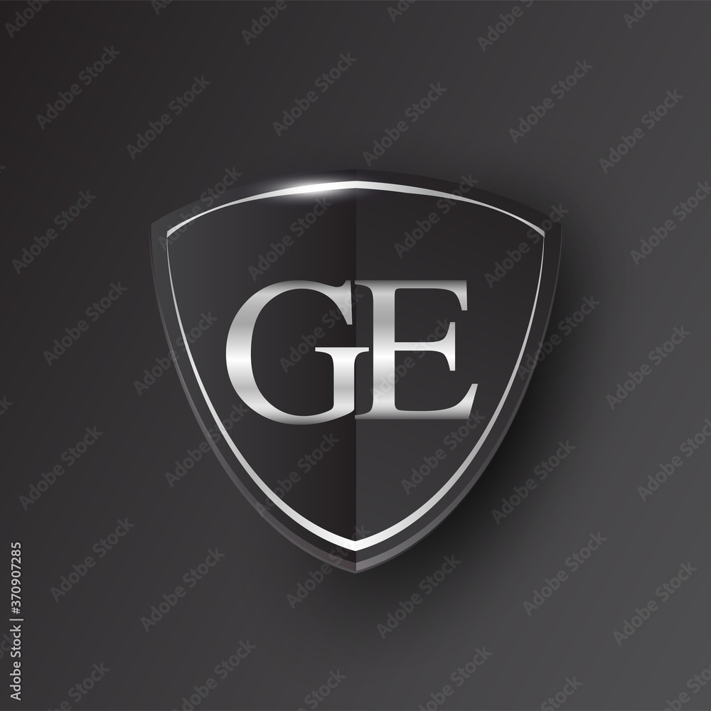 Initial logo letter GE with shield Icon silver color isolated on black ...