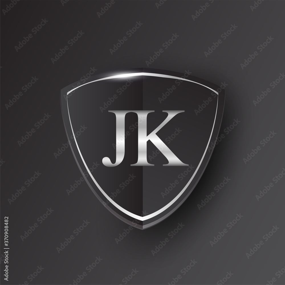 Initial logo letter JK with shield Icon silver color isolated on black ...