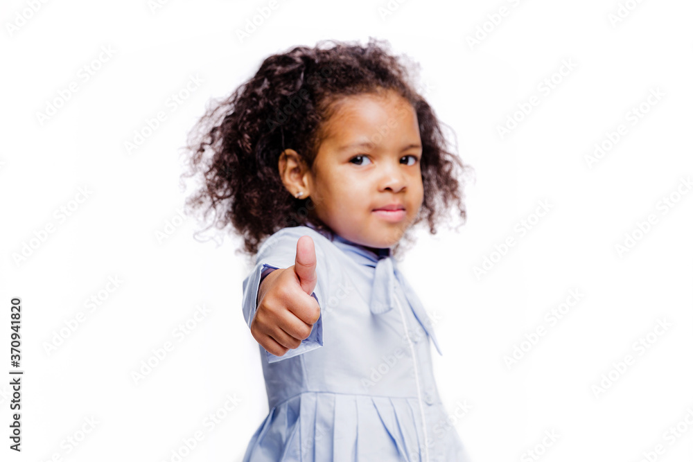 Portrait of pretty little african american girl in blue dress shows ...