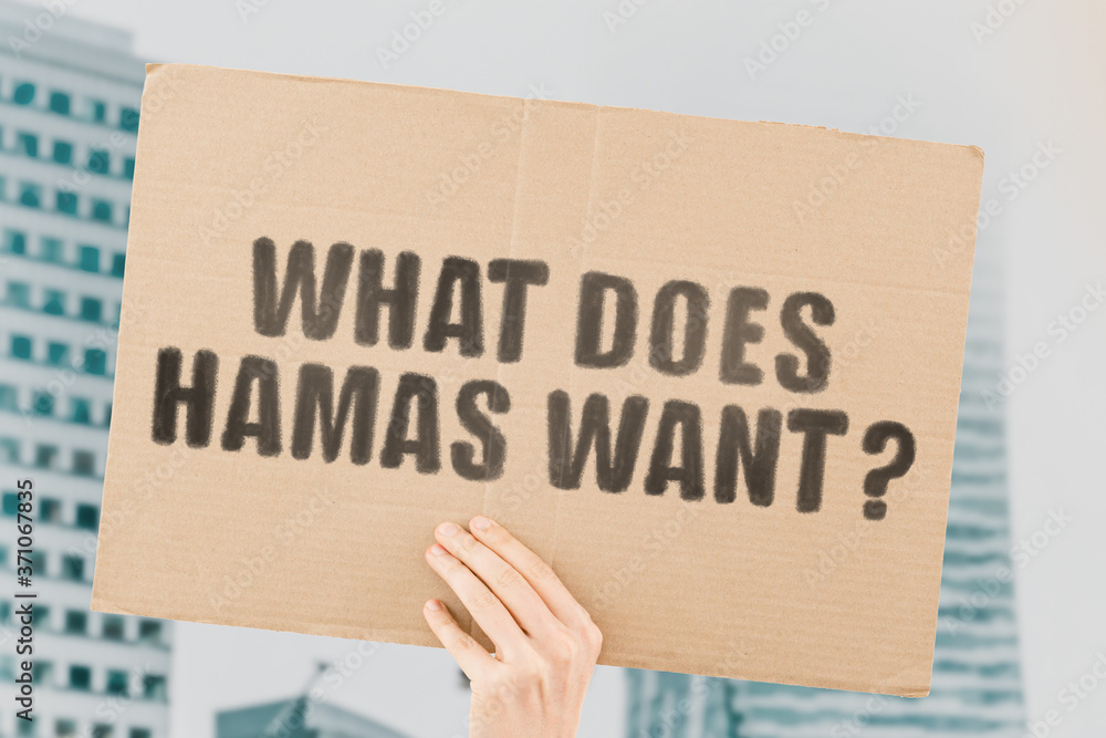 The question " What does Hamas want? " on a banner in men's hand with ...