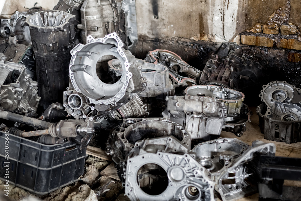 Old transmission transfer cases coated with oil and rust in a car ...